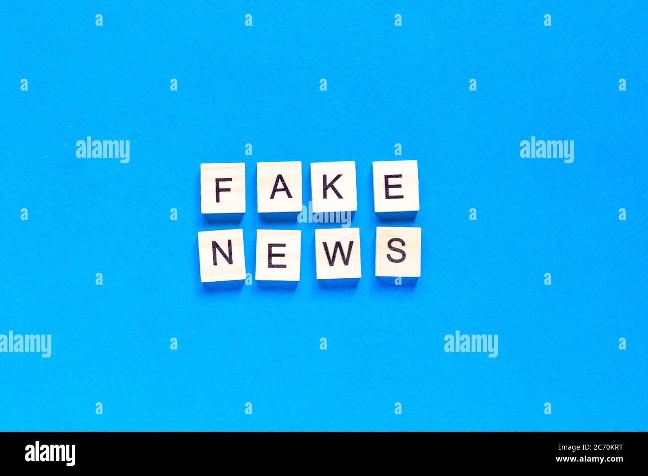 Fake news word alphabet letters on blue background. flat layout. top ...