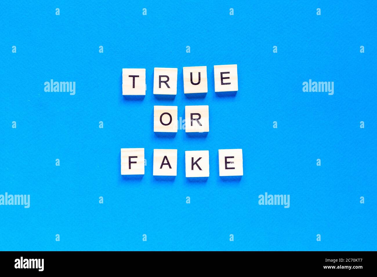 TRUE OR FAKE word alphabet letters on blue background. flat layout. top ...