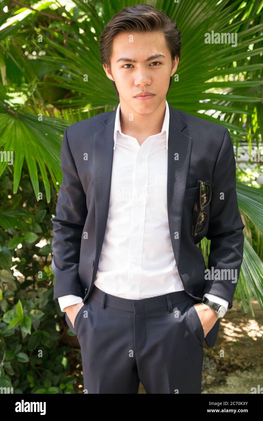 Portrait of young Filipino businessman in suit outdoors Stock Photo - Alamy