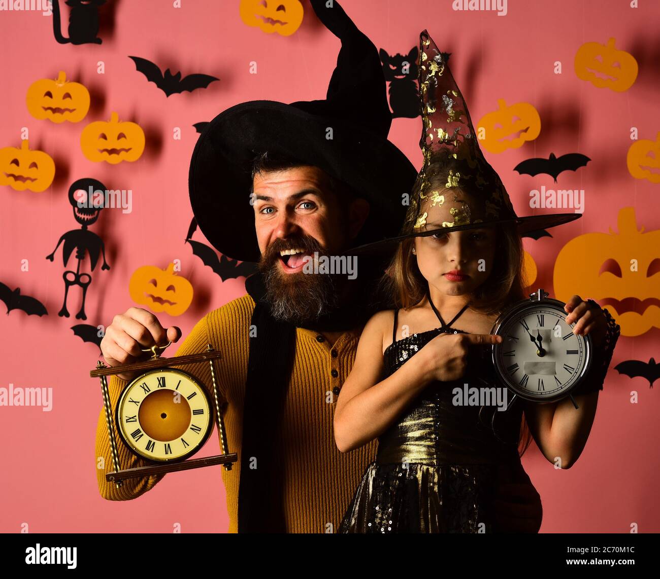 Halloween party and holiday concept. Dad and daughter in costumes ...