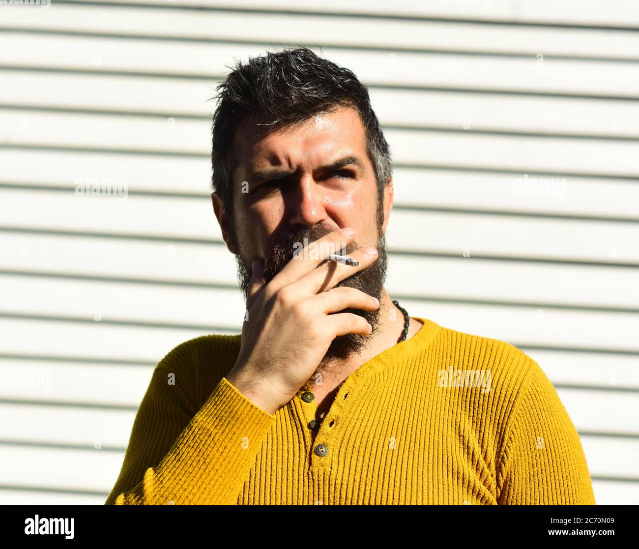 Bad habit and unhealthy lifestyle concept. Smoker holds cigarette in ...