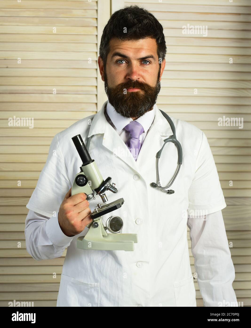 Physician with confused face ready to diagnose. Doctor in white medical ...