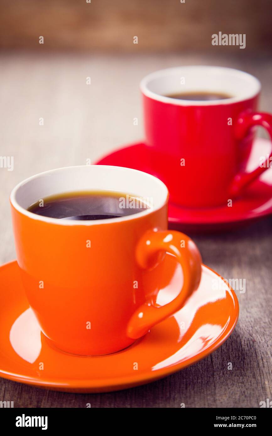 two new cups fool of coffee on wooden background Stock Photo - Alamy