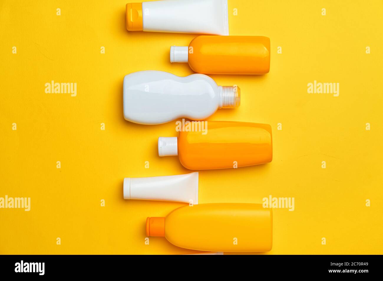Collection of sunscreen cream bottles on yellow background Stock Photo ...