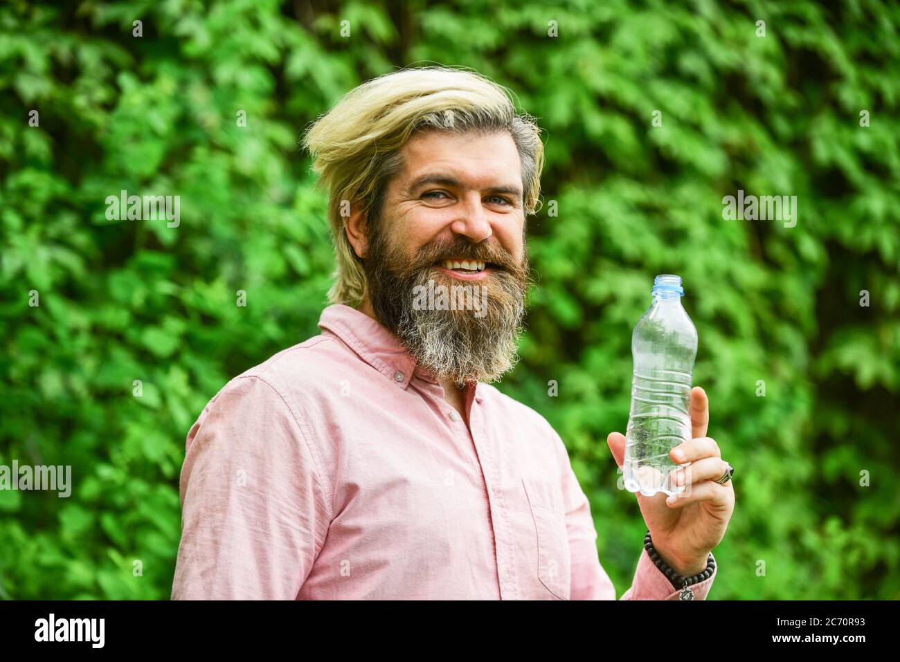 Water balance. Man bearded tourist drinking water plastic bottle nature ...