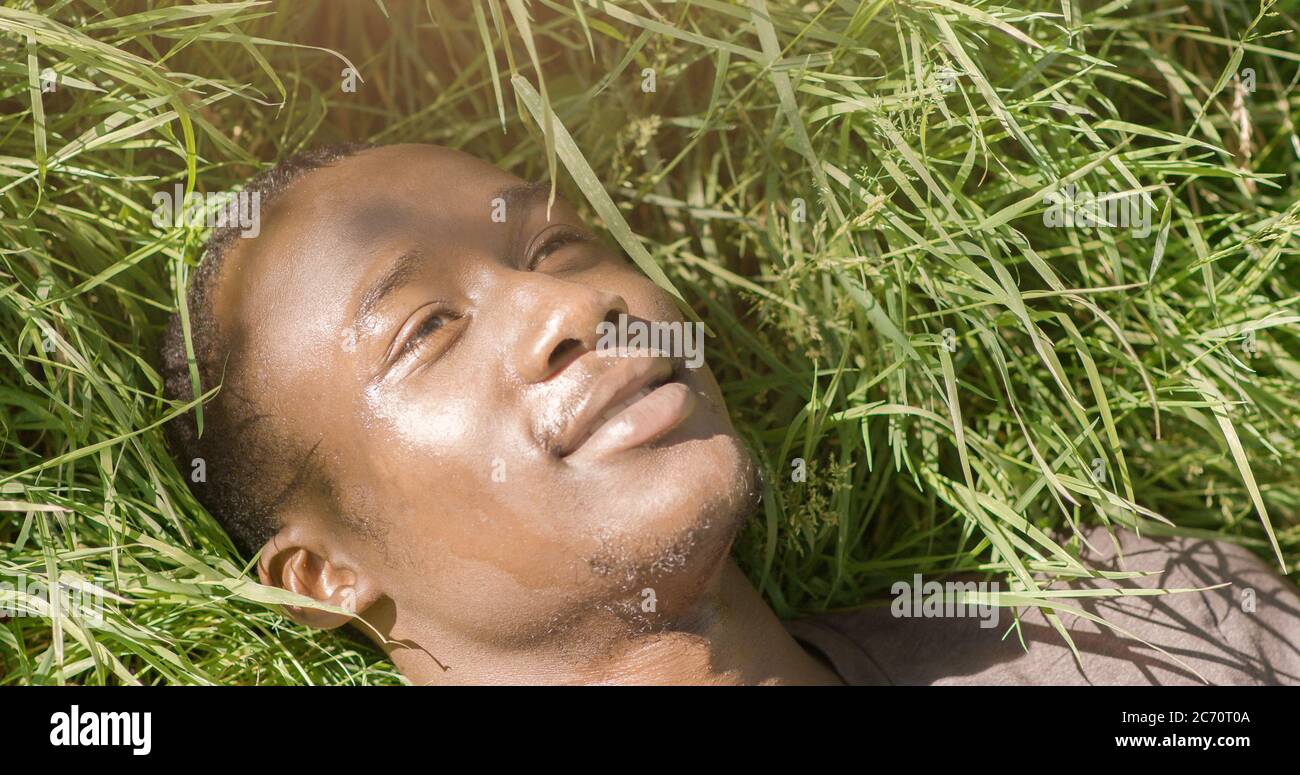 African american man sunbathing hi-res stock photography and images - Alamy
