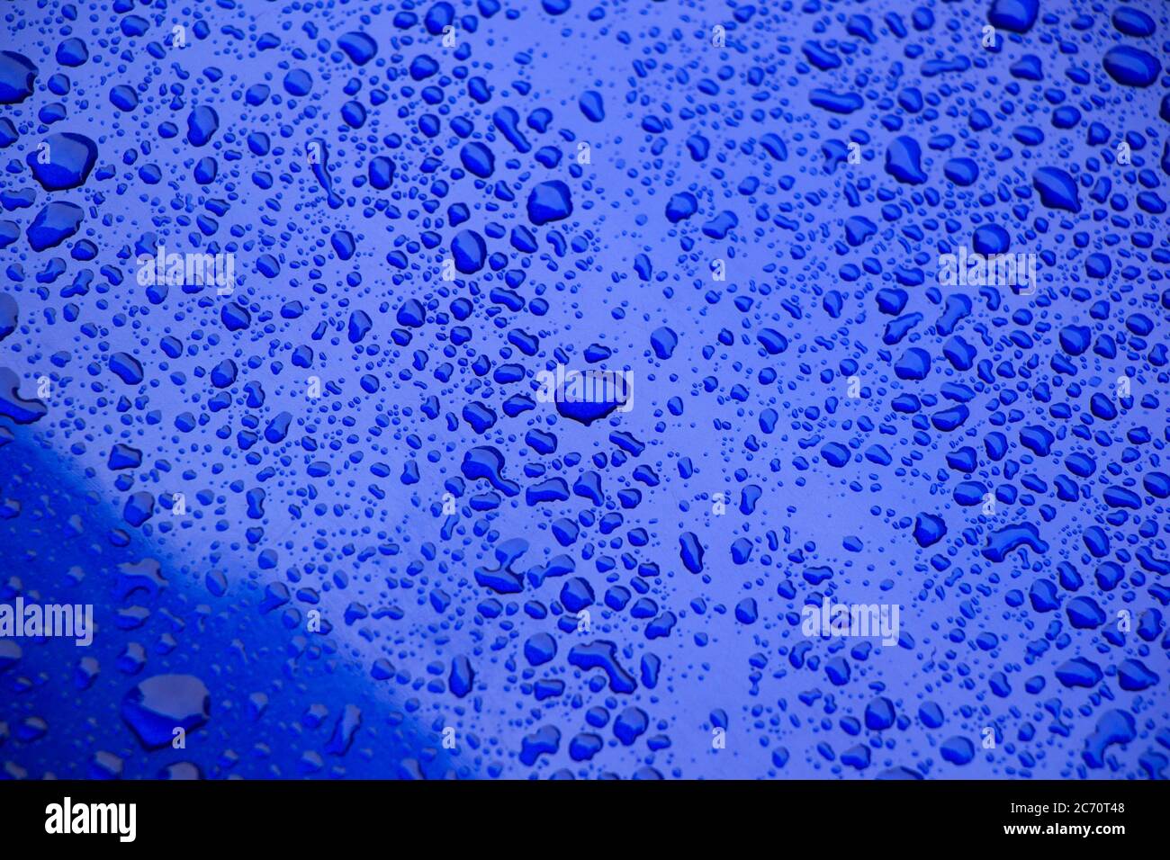 Rain drops on the blue background, blue color Stock Photo - Alamy