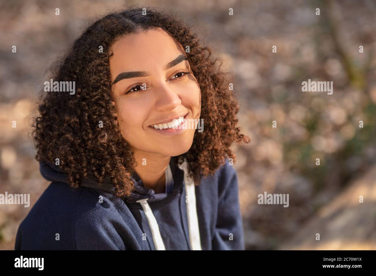 Outdoor portrait of beautiful happy mixed race biracial African ...