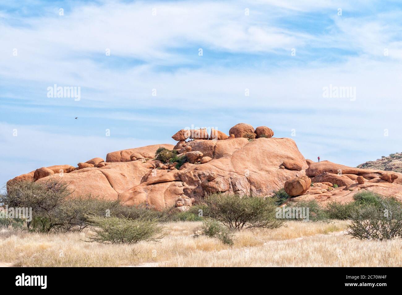 People are visible at a granite rock formation, resembling a broken ...