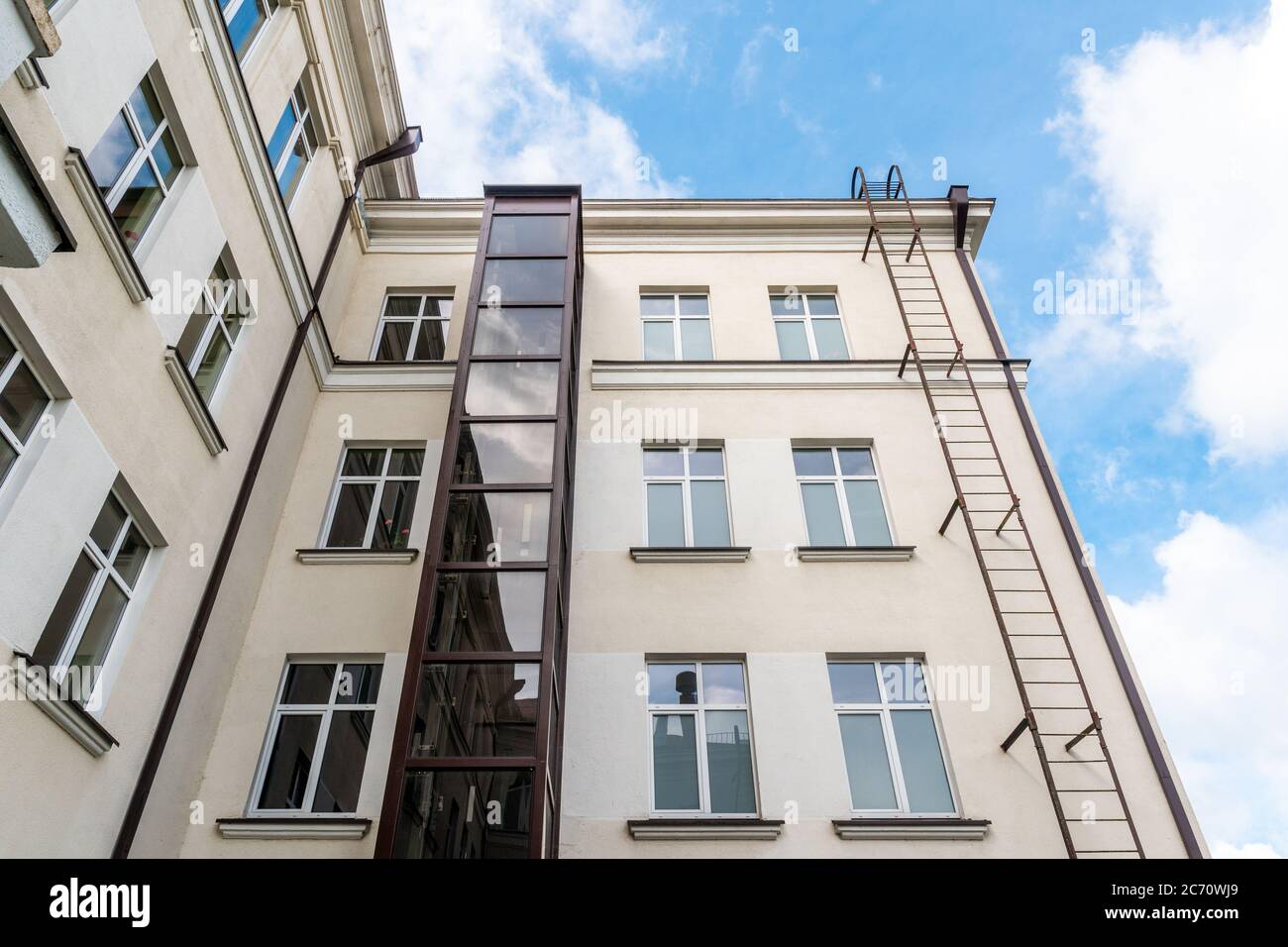 Glass elevator on a house facade. An example of living solution for ...