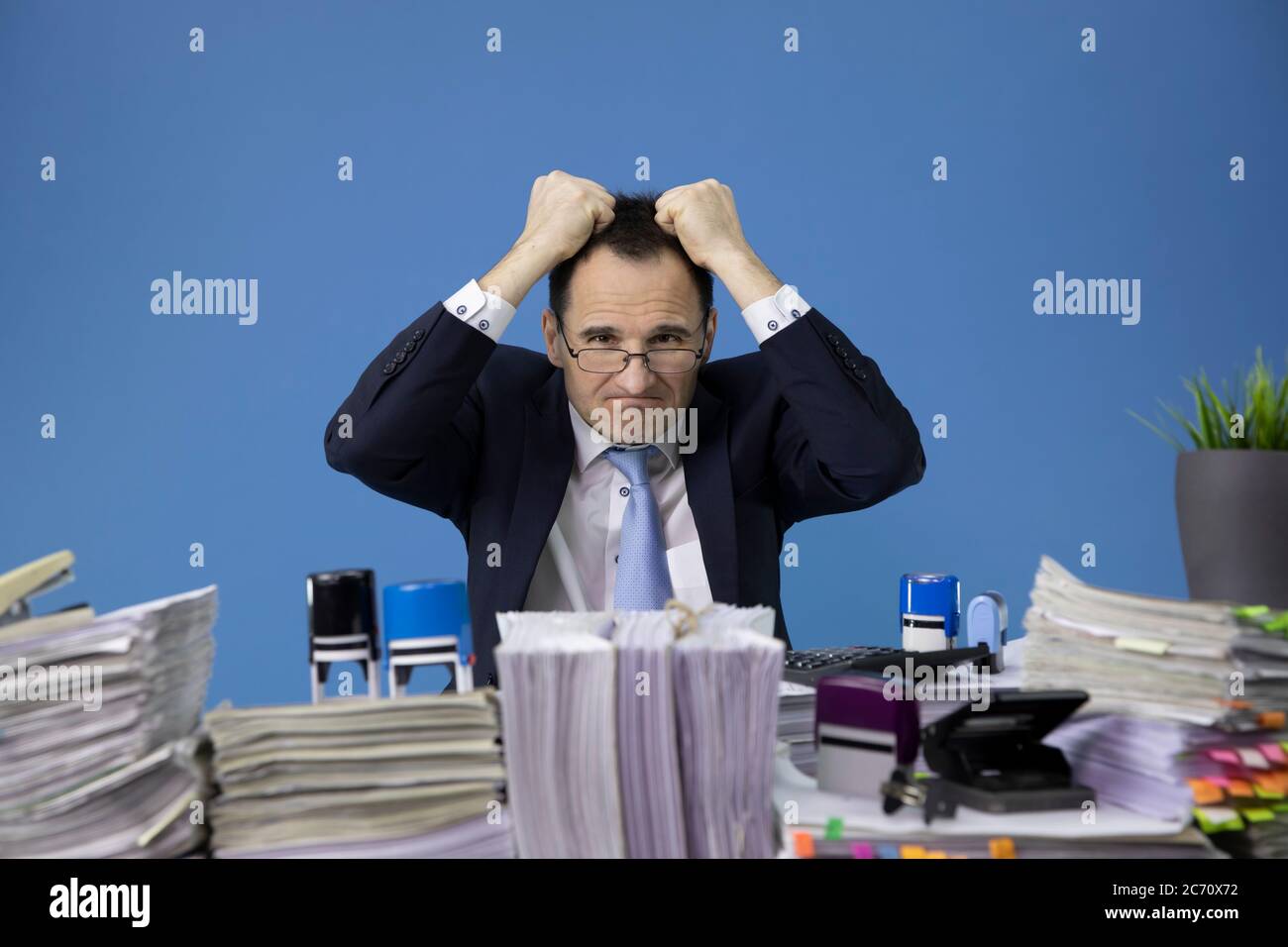 Office clerk is angry, screaming and tearing hair on his head Stock ...