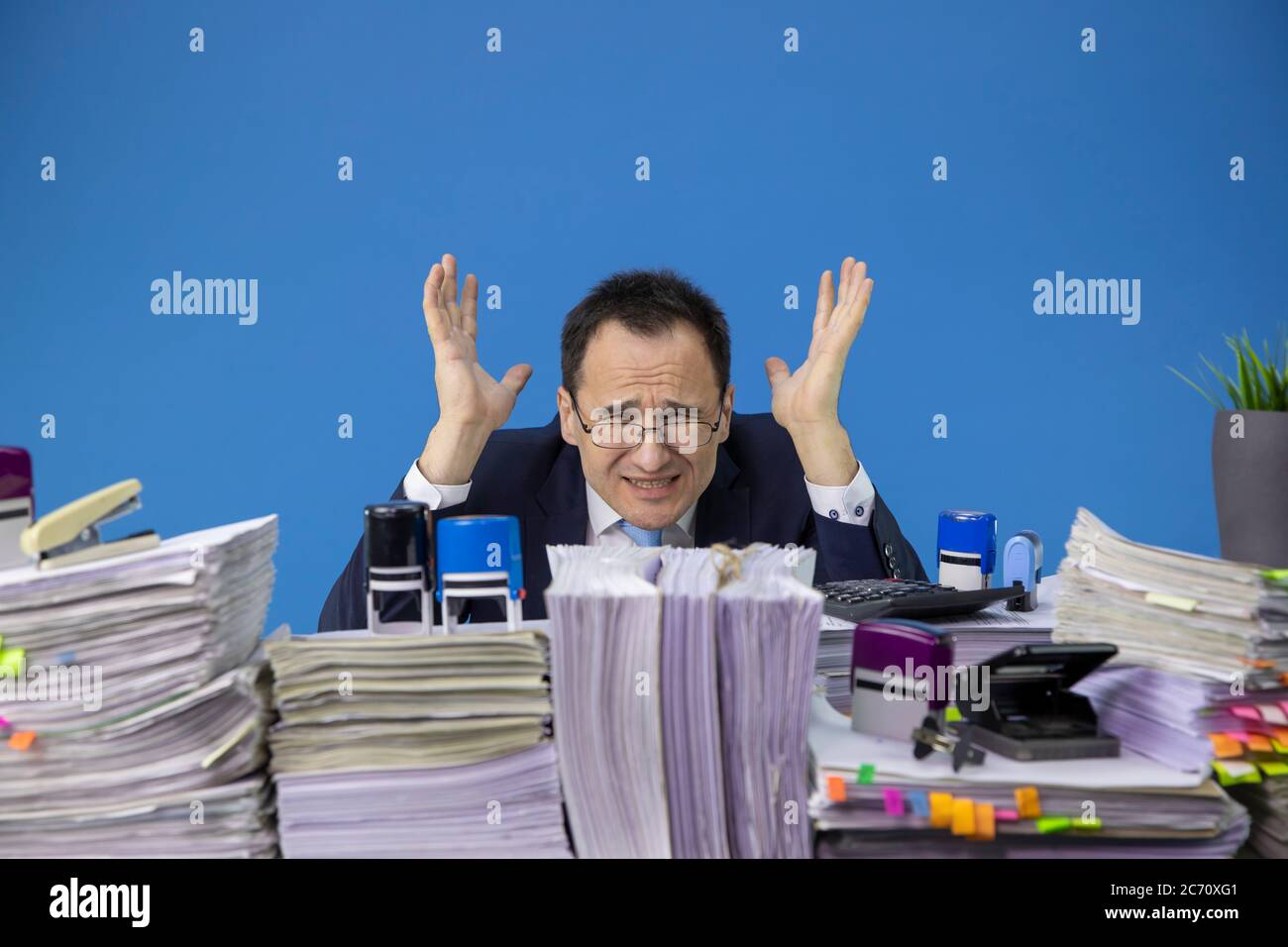 Office manager in a suit and glasses is shocked and amazed at the ...