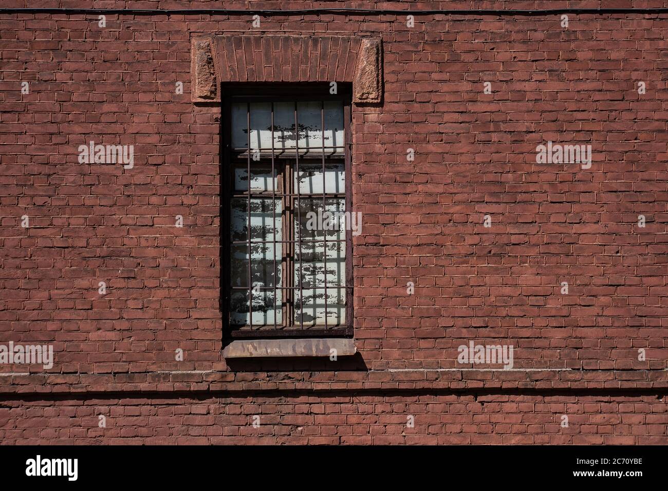 Old window with bars on a brick wall Stock Photo - Alamy