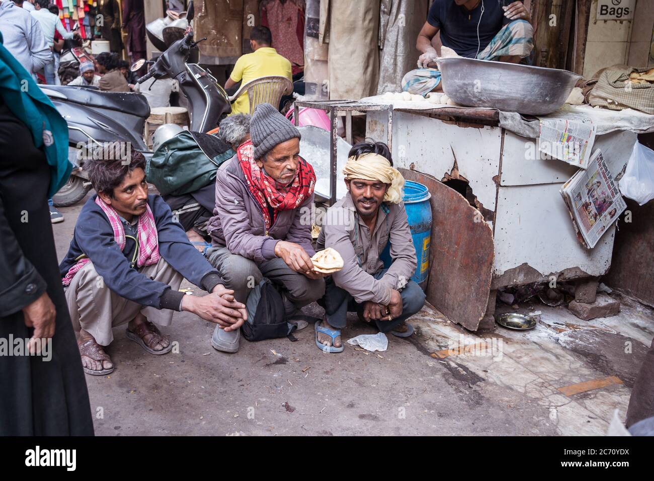 New Delhi / India - February 18, 2020: Group of poor beggars crouching ...