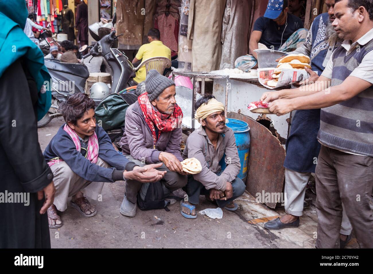 New Delhi / India - February 18, 2020: Group of poor beggars crouching ...