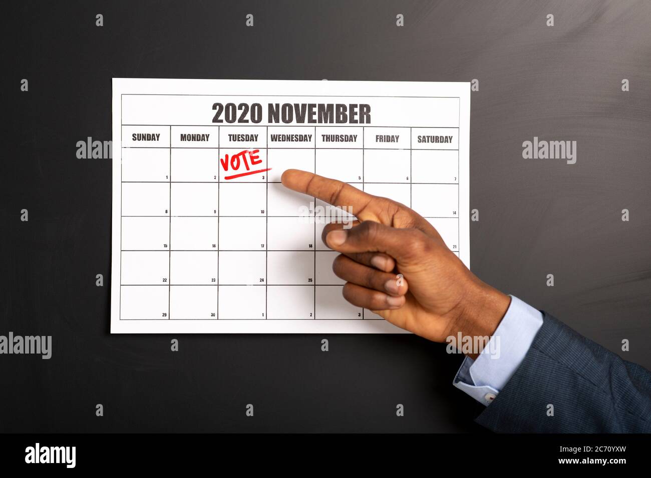 African businessman hand writing reminder in calendar Stock Photo - Alamy