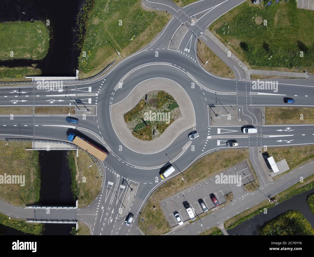 Aerial top down view of a traffic roundabout on a main road in an urban ...