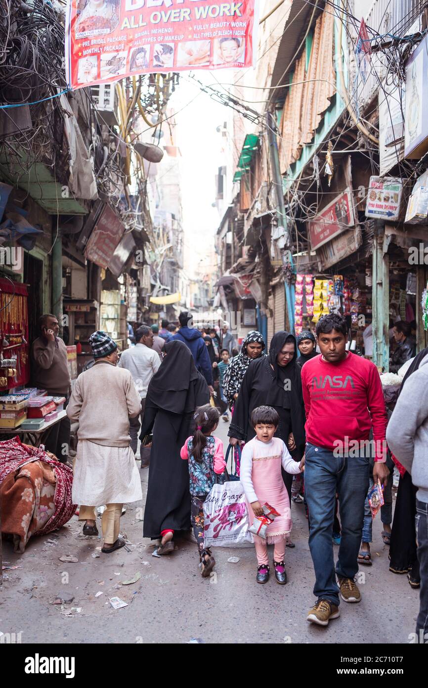 New Delhi / India - February 18, 2020: Muslim family walking down alley ...