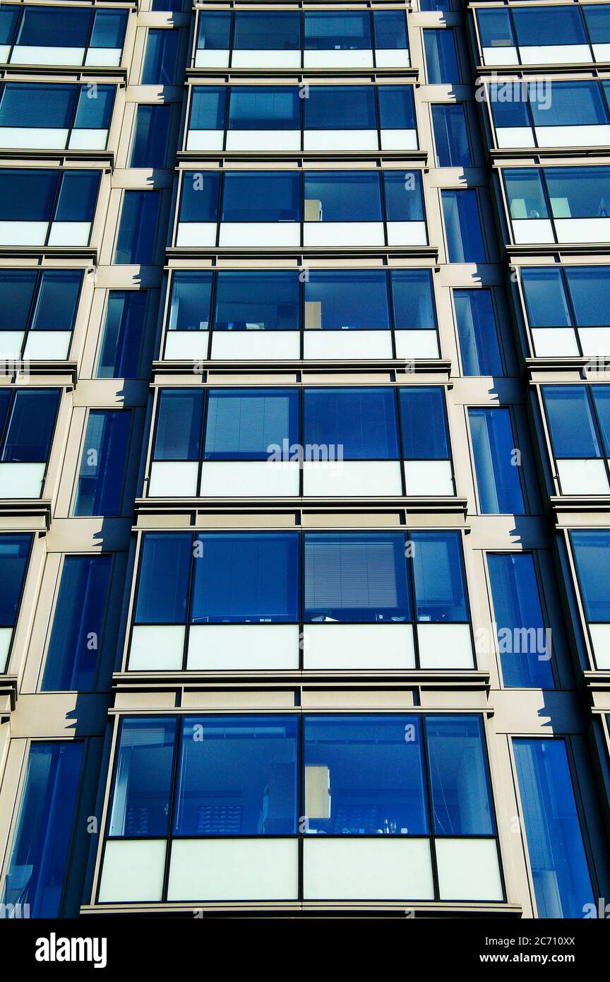 Reflection of a modern skyscraper office block in glass windows Stock ...