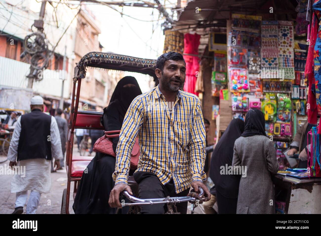 New Delhi / India - February 18, 2020: Rickshaw carrying Muslim woman ...