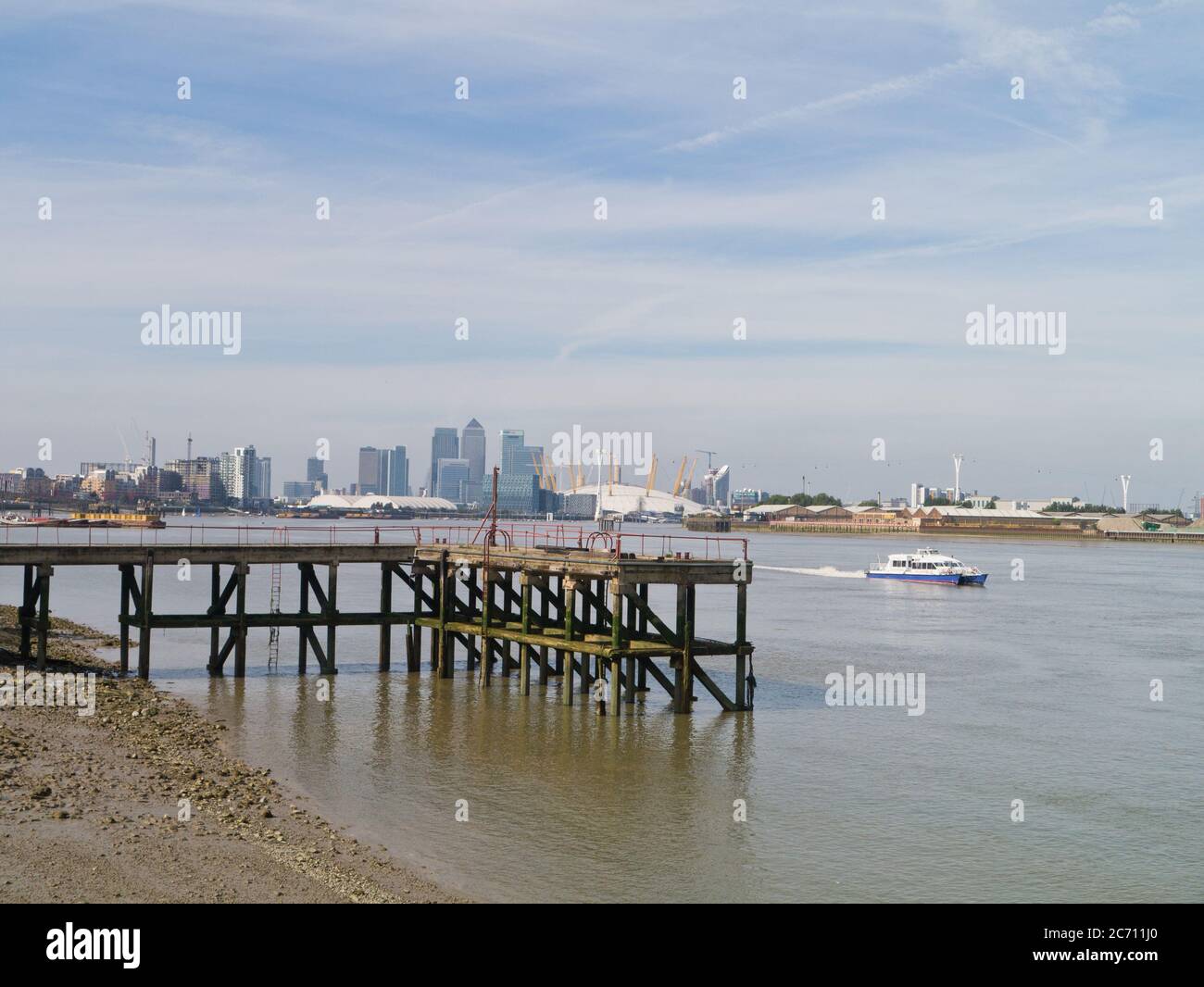 South bank of the River Thames at Woolwich, UK; London skyline with old ...