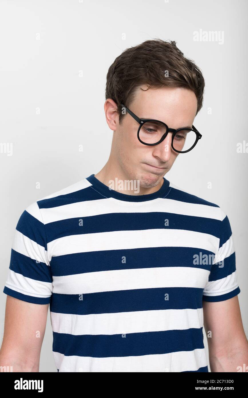 Portrait of stressed young nerd man thinking and looking down Stock ...
