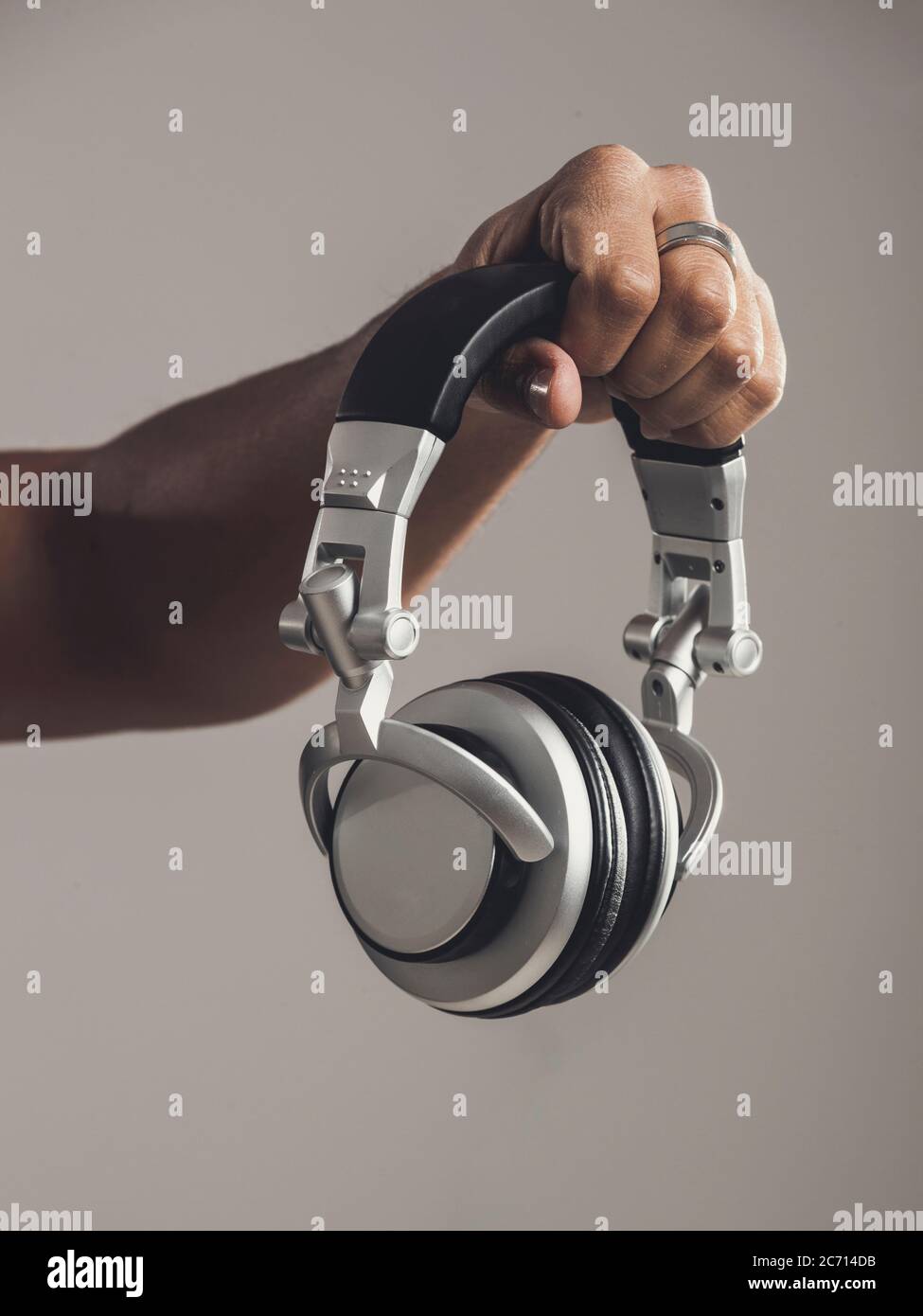 DJ hand holding his headphones Stock Photo - Alamy