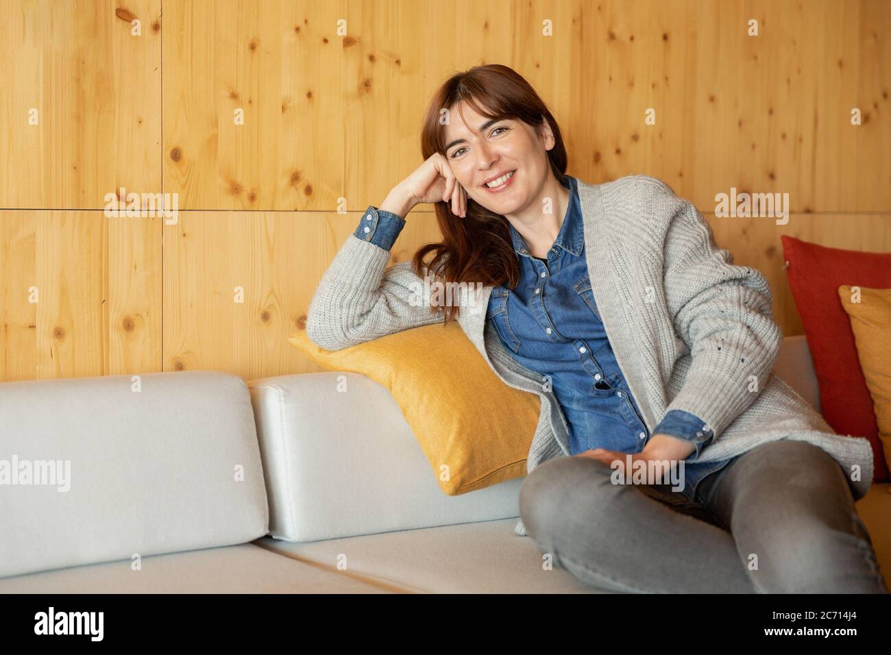 Beautiful woman sitting and relaxing on a cozy place Stock Photo - Alamy