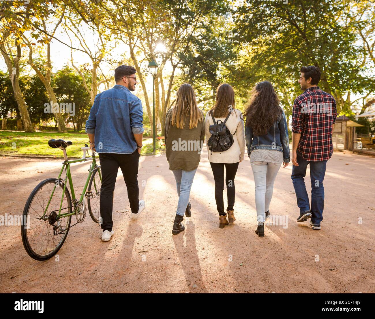 Group of students walking together in the park Stock Photo - Alamy