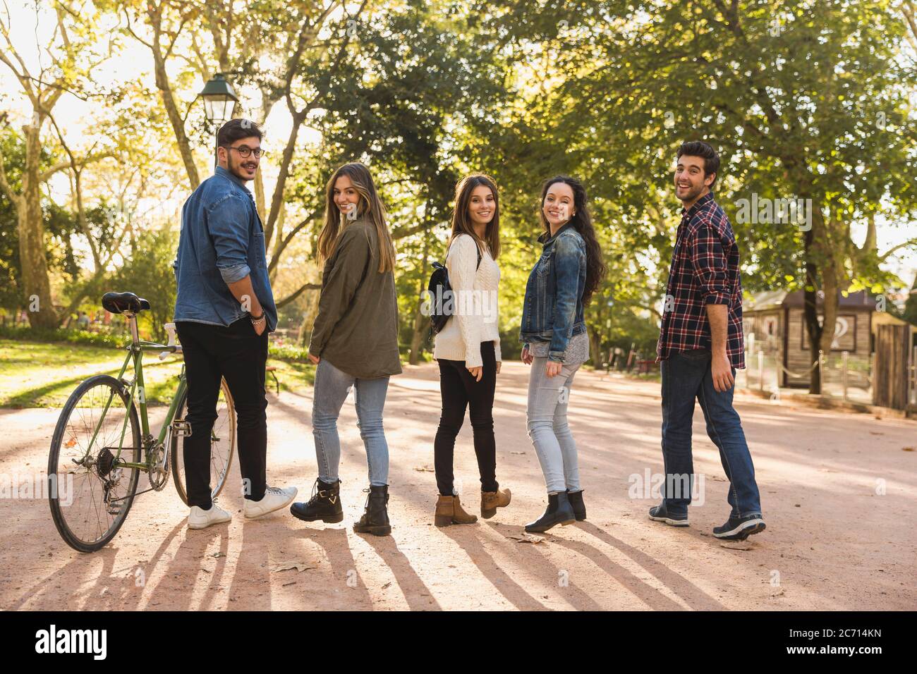 Group of students walking together in the park Stock Photo - Alamy