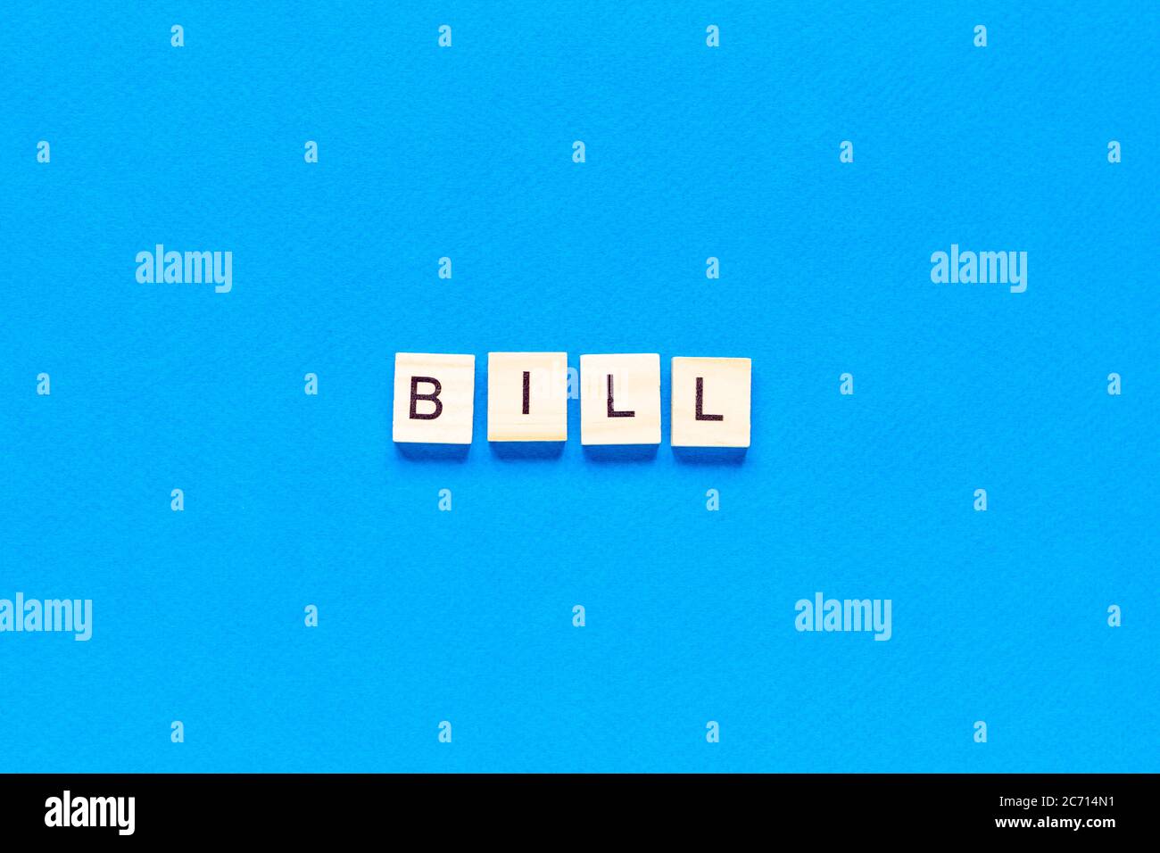 bill in wooden letters on a blue background, flat layout, top view ...