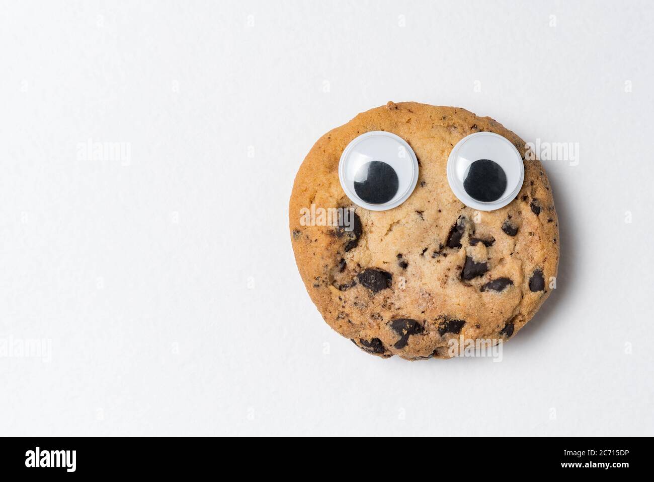 Cookies with funny face and Googly eyes on white background. Copy space ...