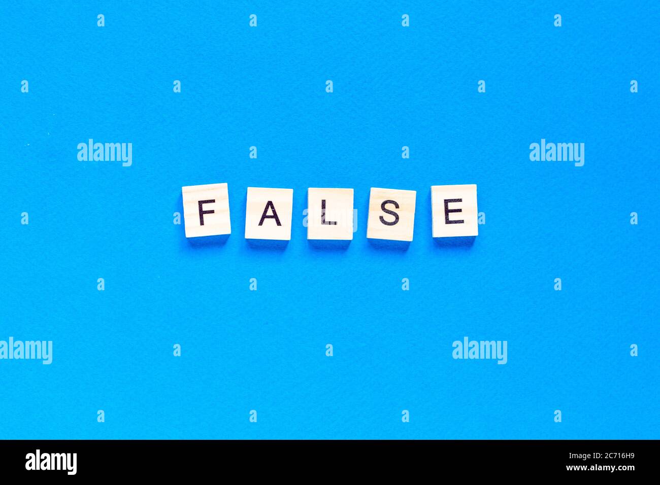 FALSE word alphabet letters on blue background. flat layout. top view ...