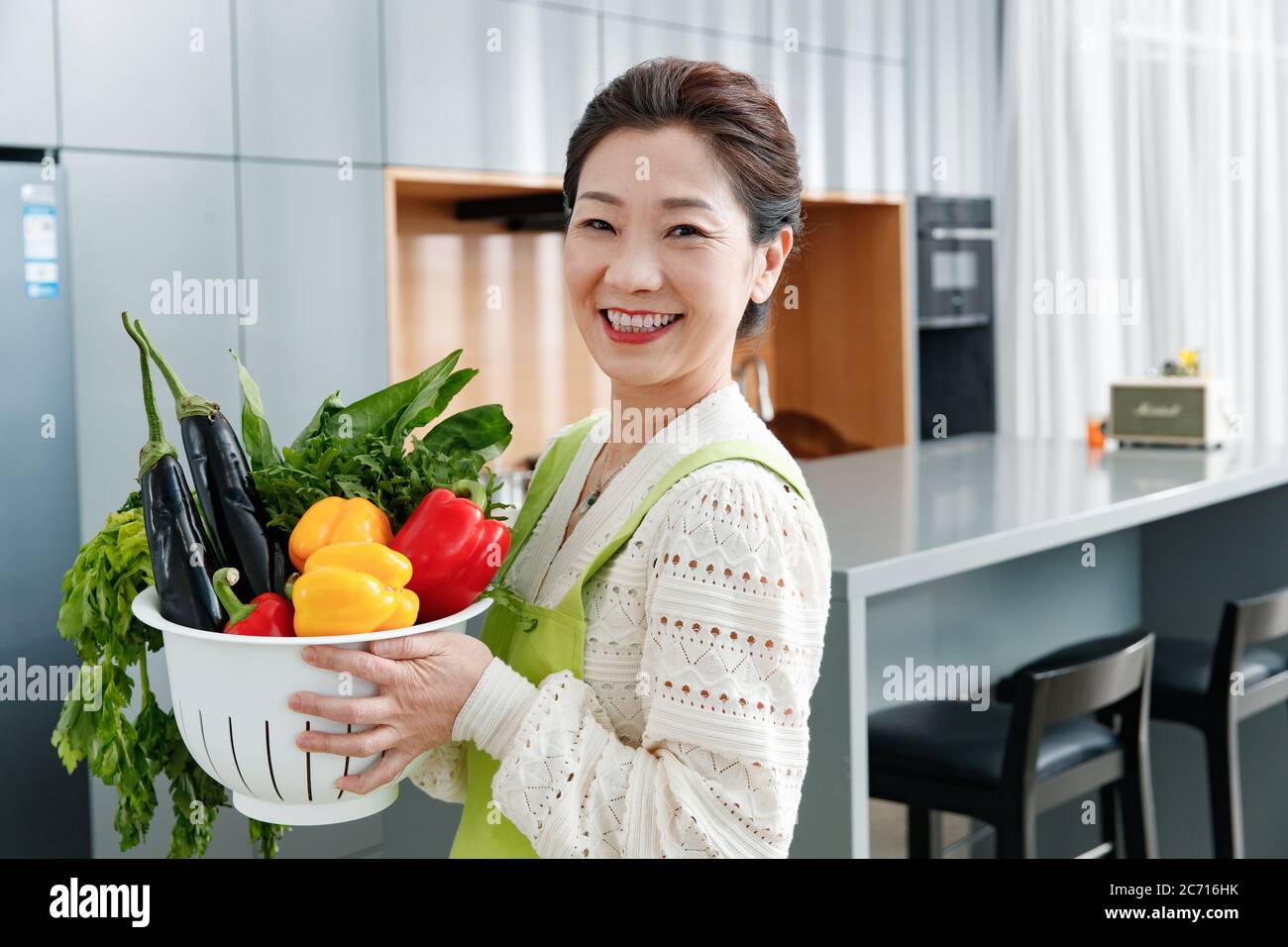 Indian lady cooking in kitchen hi-res stock photography and images - Alamy