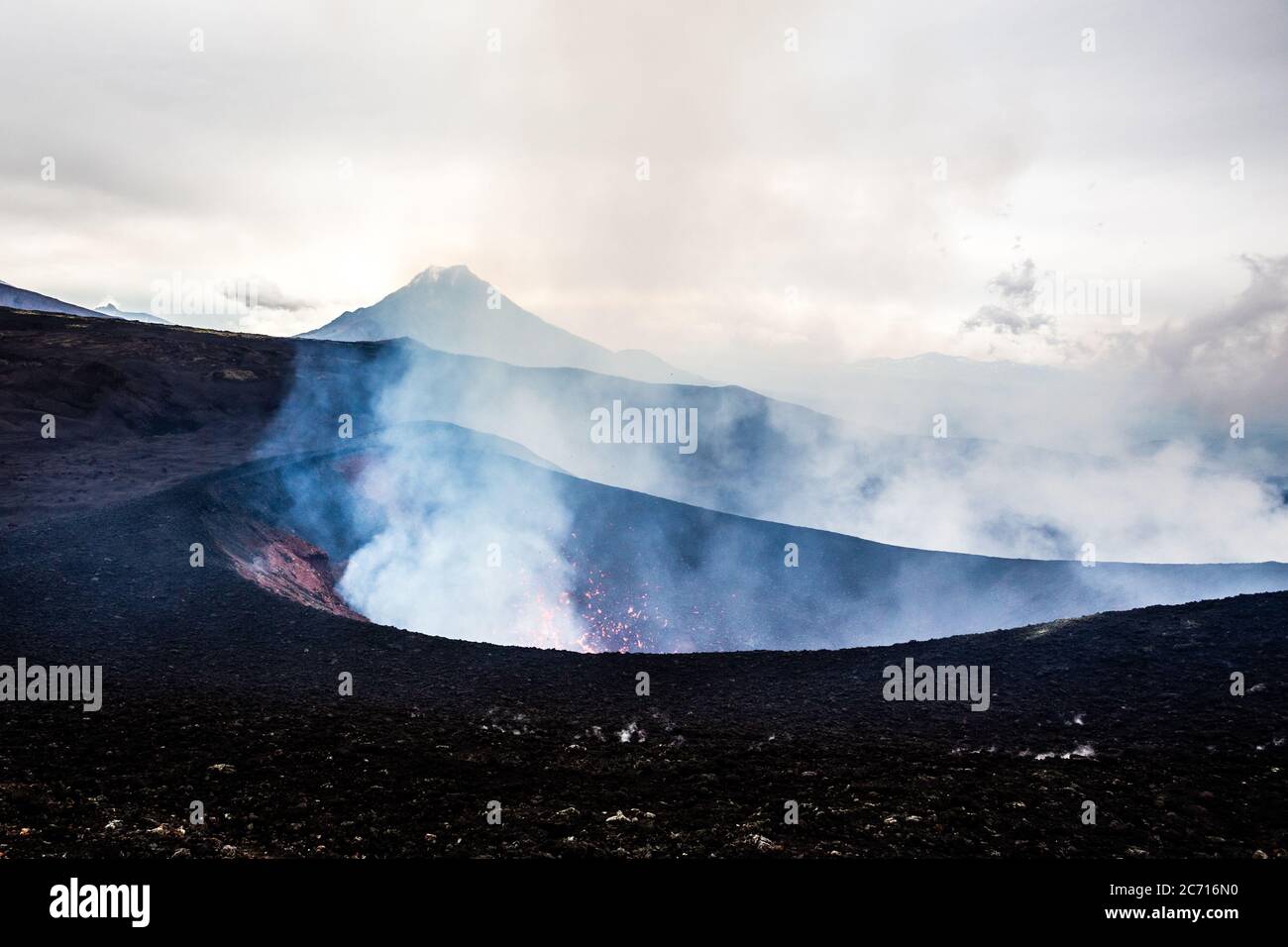 Crater of erupting volcano on the overcast weather, volcanic landscape ...