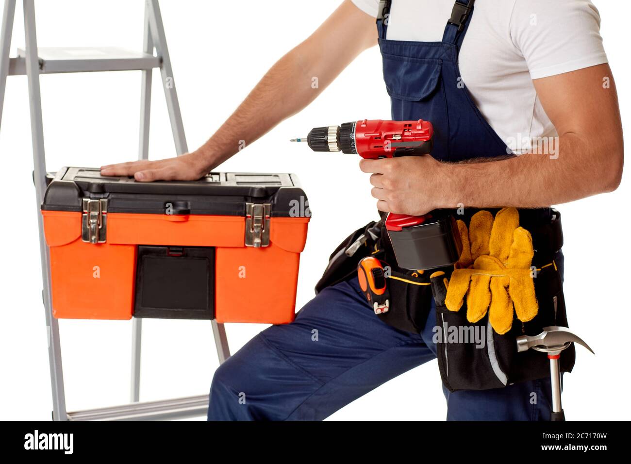 repairman holding cordless screwdriver and tool box. handyman with ...