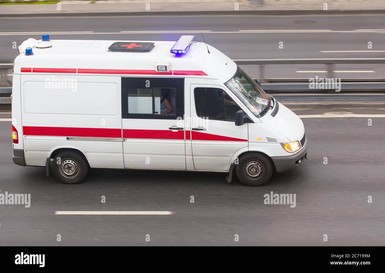 car of an emergency medical service goes on the city street Stock Photo ...