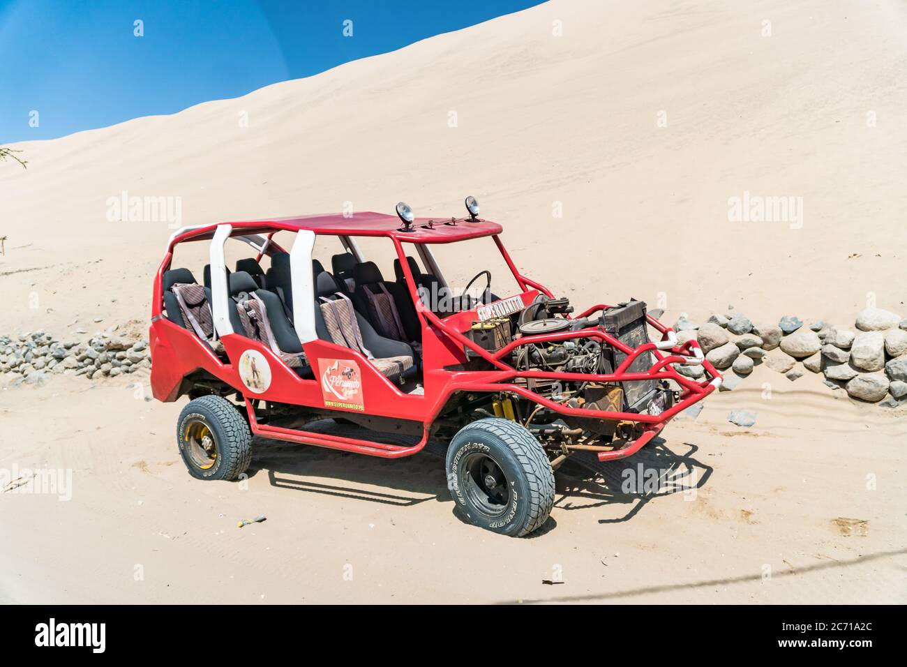 Huacachina, Peru - August 2017: Dune buggy at the foot of a large sand ...