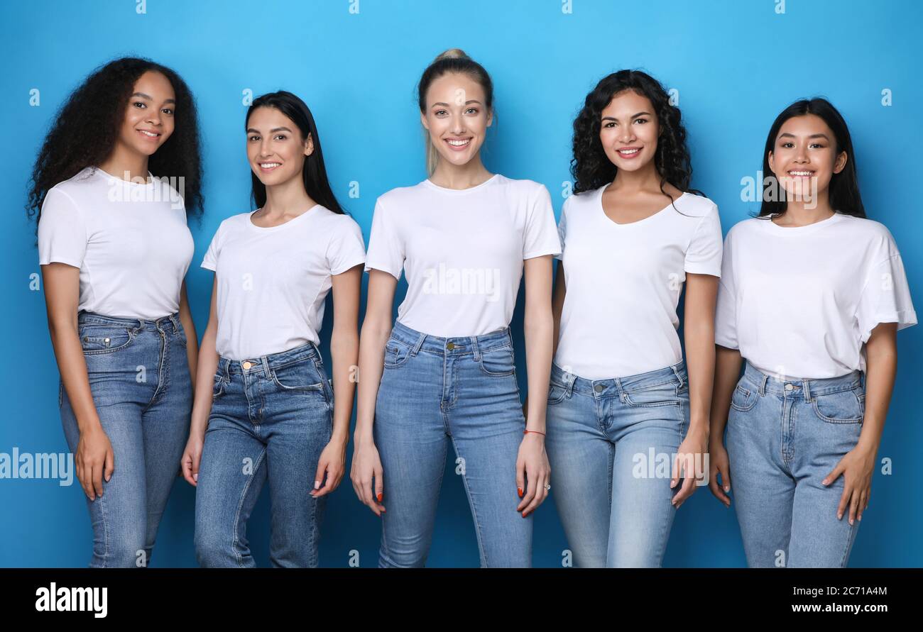 Five Model Girls Smiling To Camera Posing Over Blue Background Stock ...