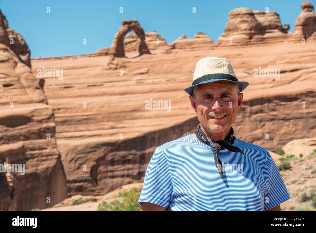 Happy caucasian tourist along the trail to The Delicate Arch, Arches ...
