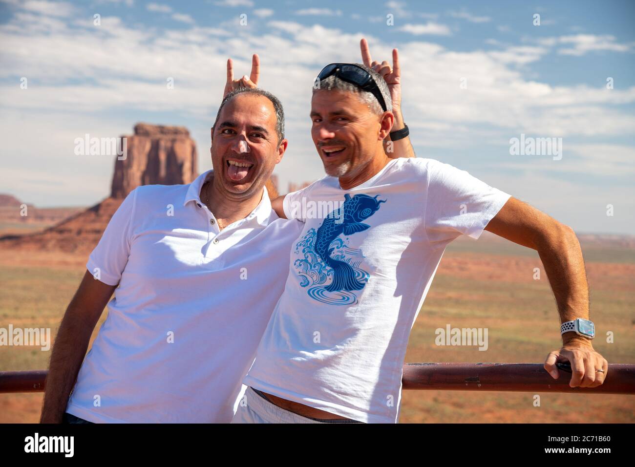 Two men joking and having fun visiting Monument Valley, USA Stock Photo ...