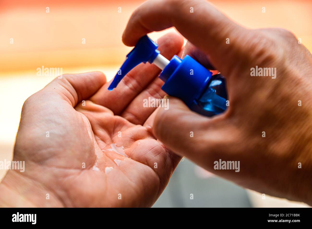 Hand sanitising with disinfectant gel Stock Photo - Alamy