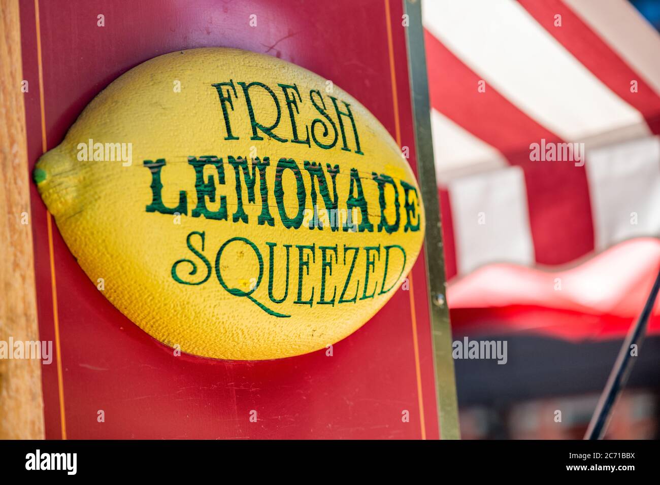 Fresh squeezed lemonade sign with white and red tent on background ...