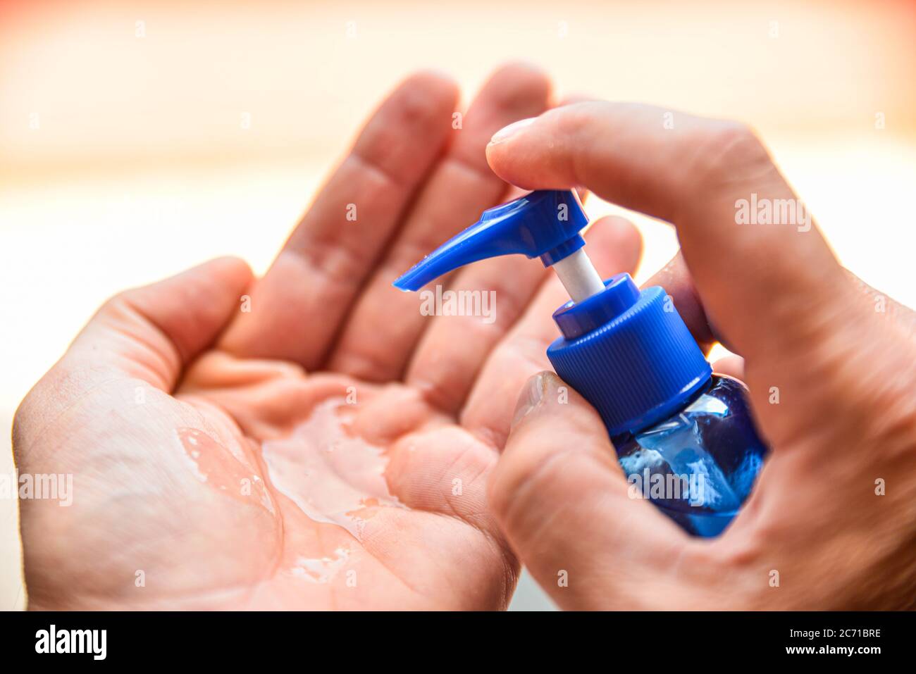 Hand sanitising with disinfectant gel Stock Photo - Alamy