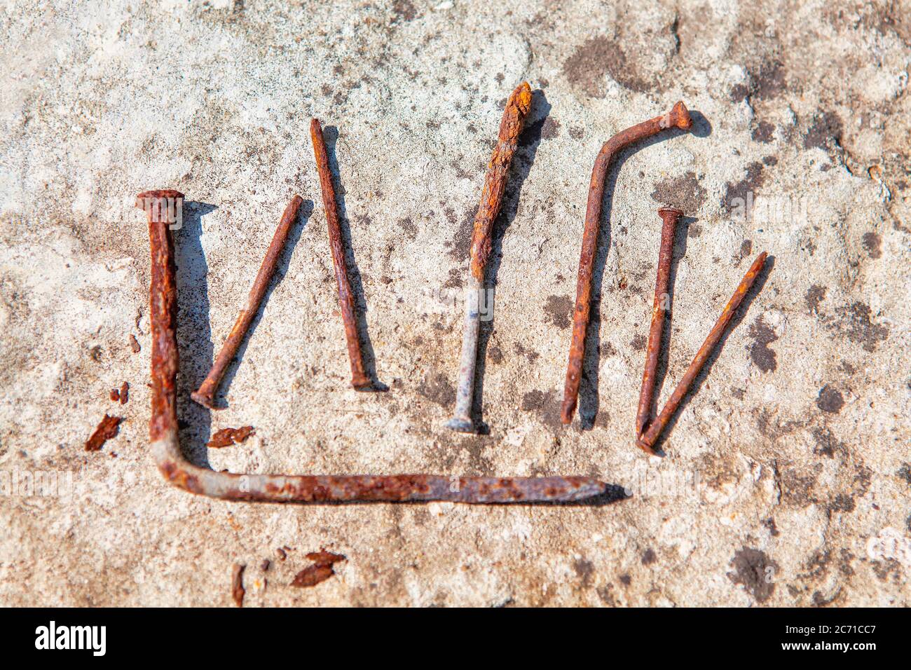 Rusty used nails on a dirty surface Stock Photo - Alamy