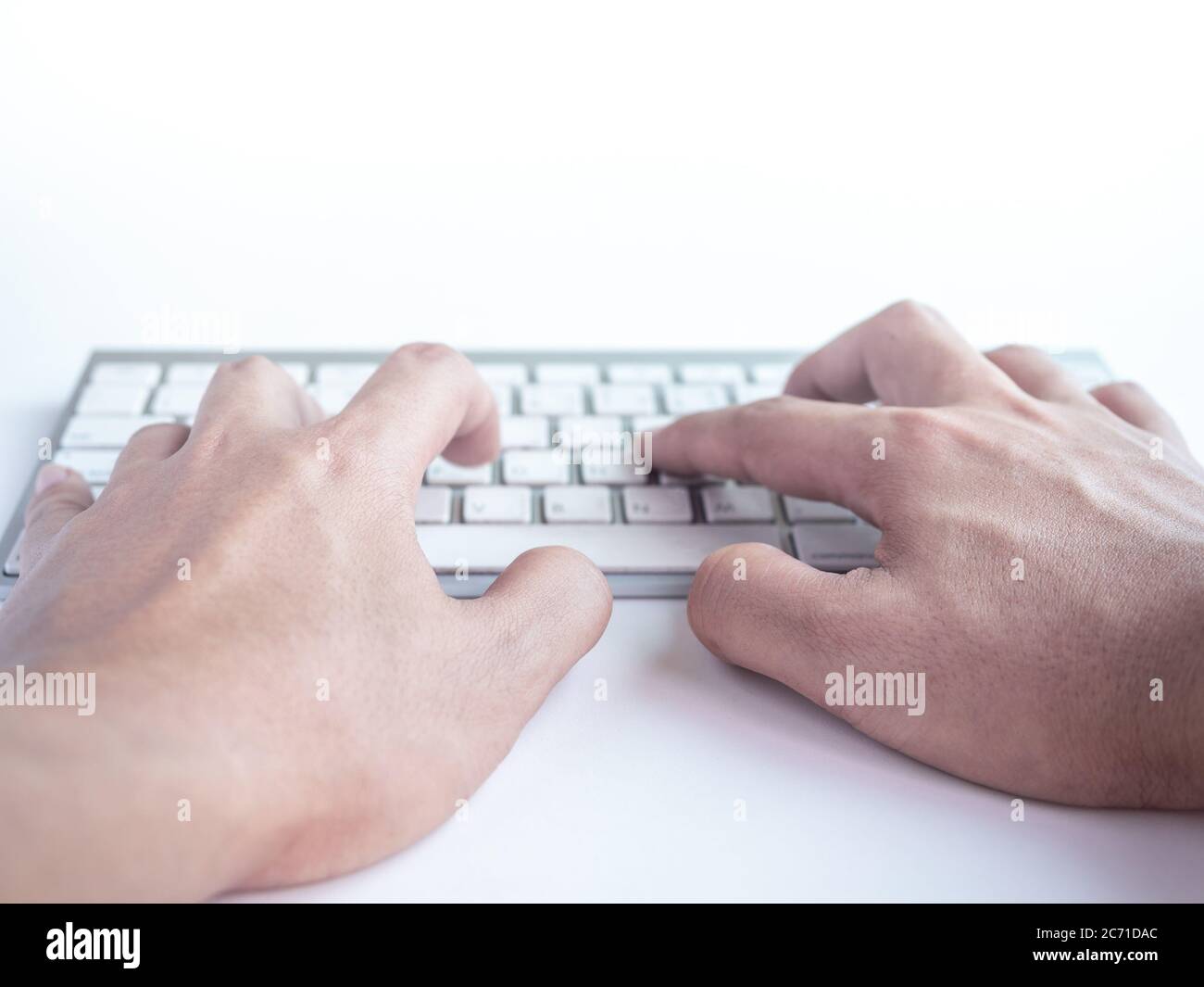 Close-up hands typing on remote control wireless computer keyboard ...