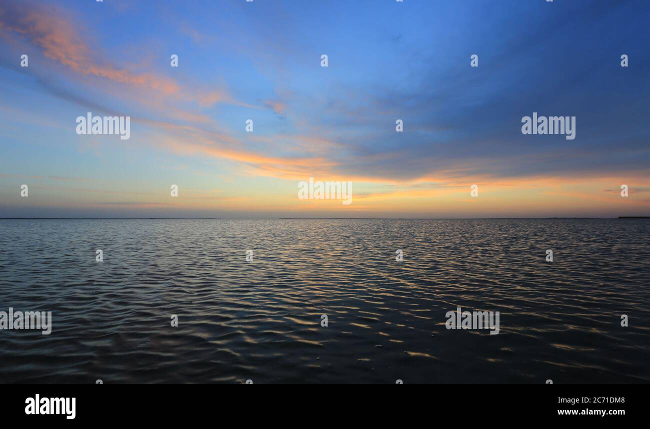Serene sunset over empty beach hi-res stock photography and images - Alamy