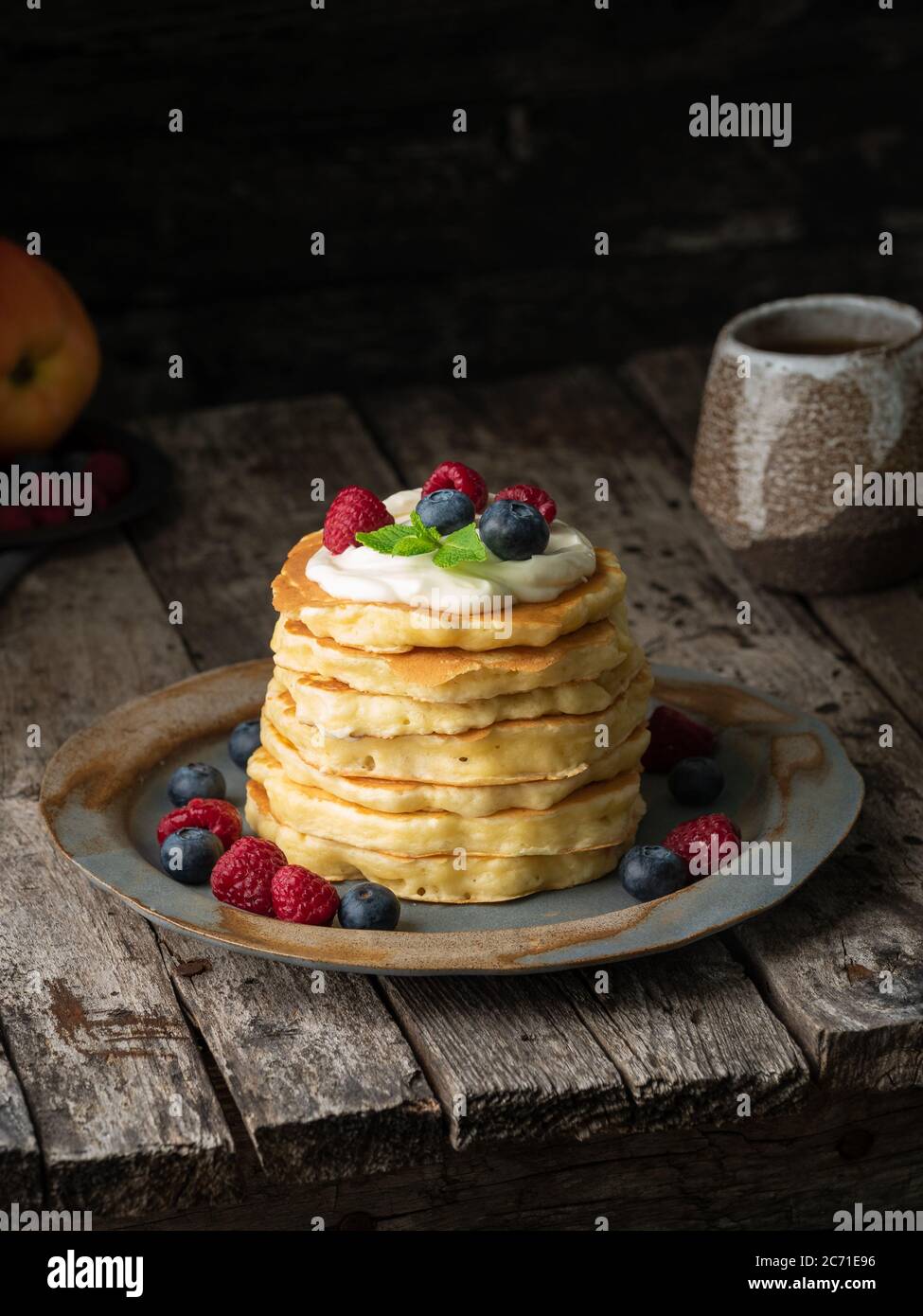 Pancake with vanilla cream, blueberries and raspberries. Side view ...
