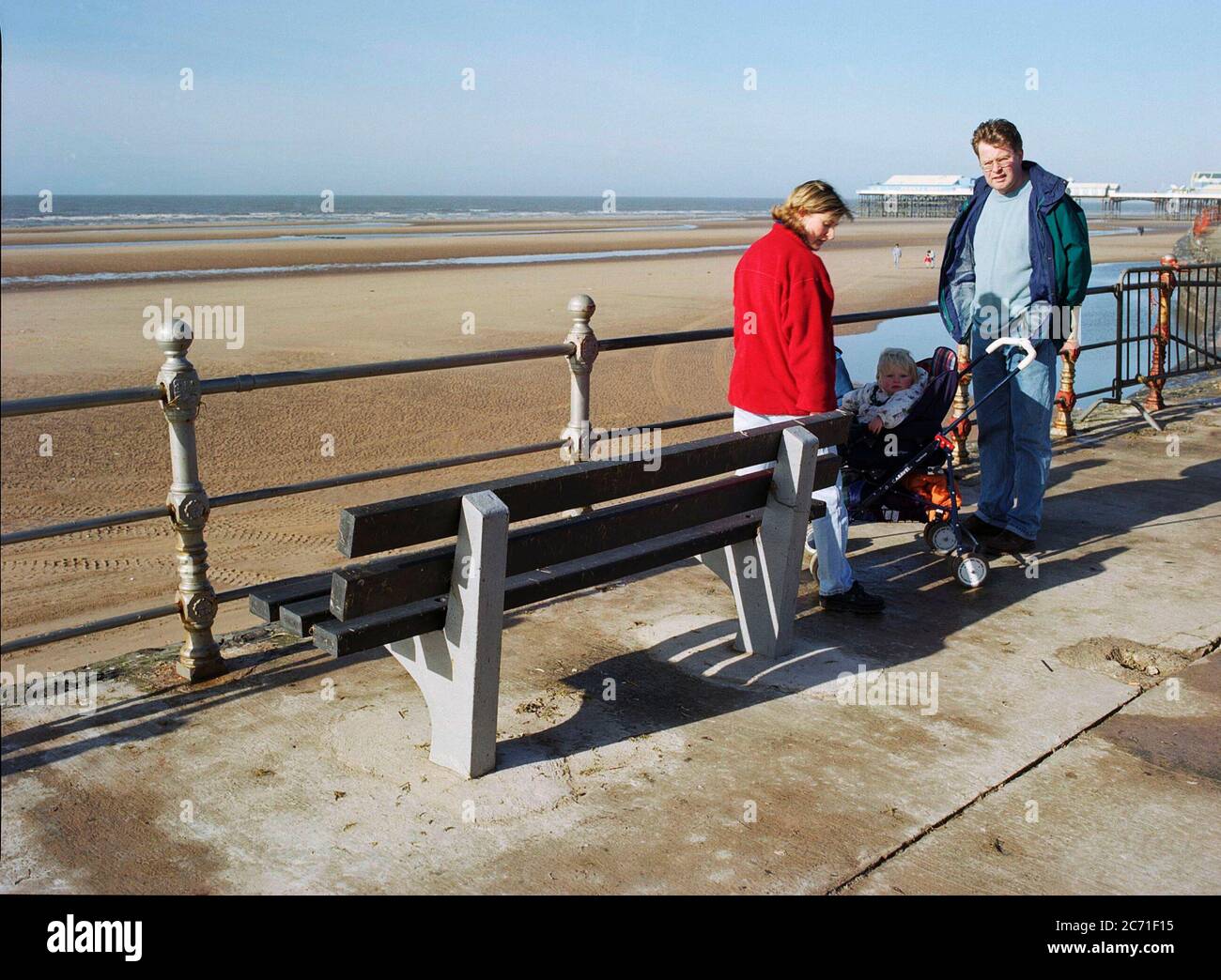 People sitting on a bench on Blackpool Sea Front, north west England ...