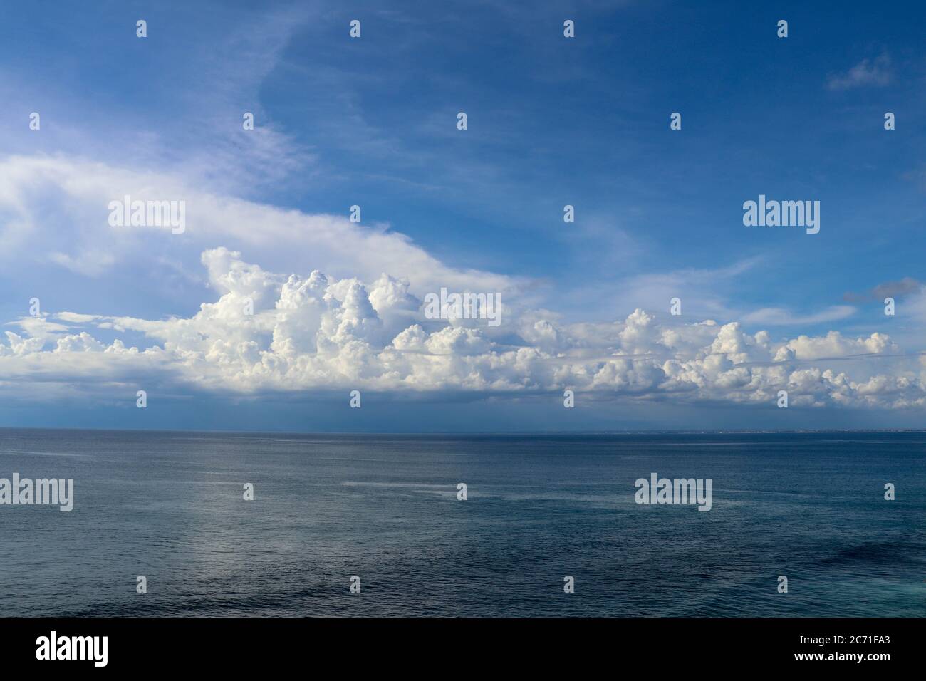 Calm sea and blue sky from the side of a boat with bow wave wake and ...